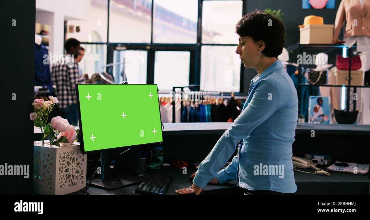 Manager looking at computer with chroma key green screen mock up ...