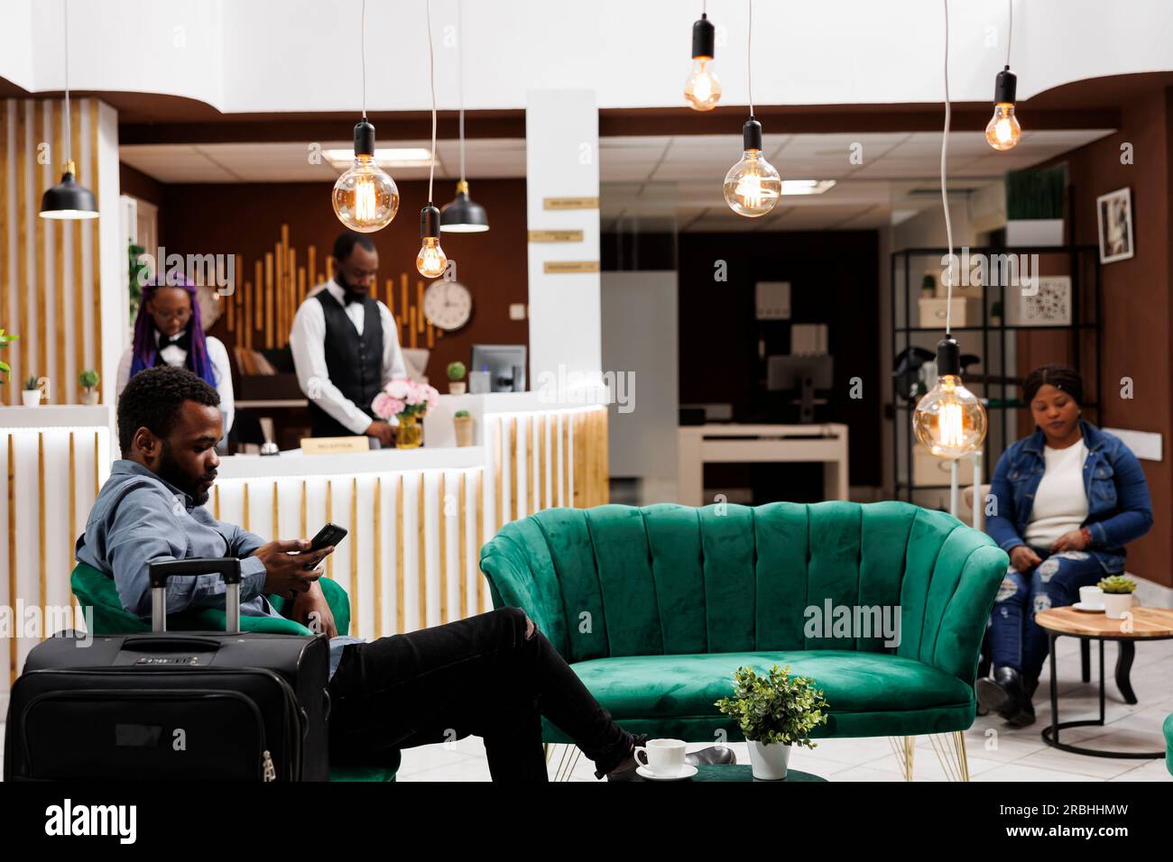 People tourists man and woman waiting for room at hotel lounge area ...
