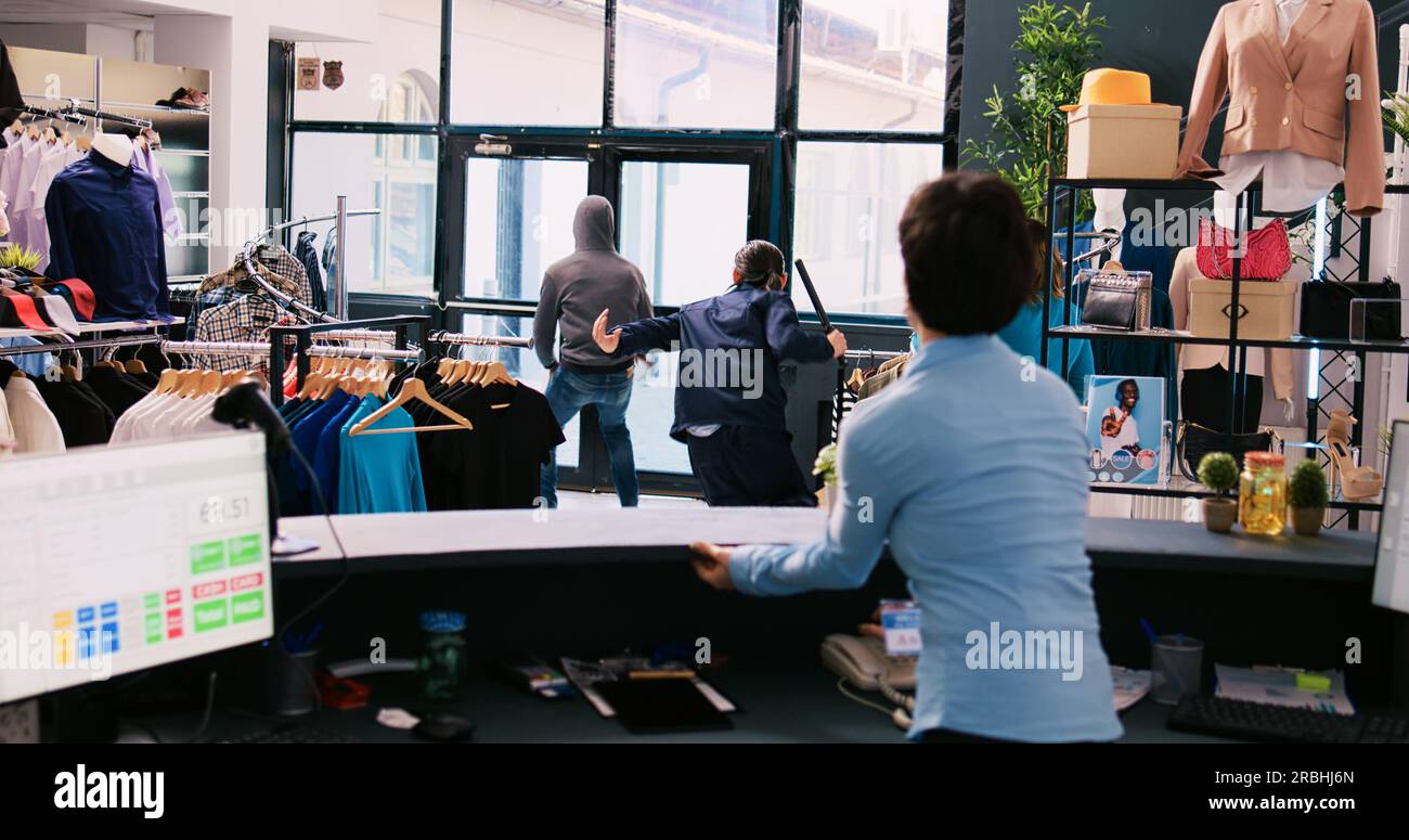 African american thief stealing trendy clothes, running from shopping ...