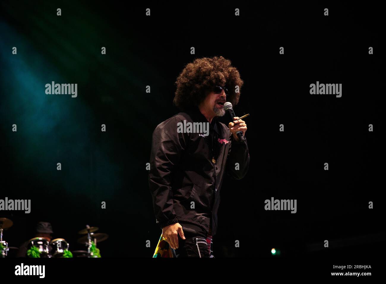 B-Real of Cypress Hill performs on stage sporting sunglasses, a large ...