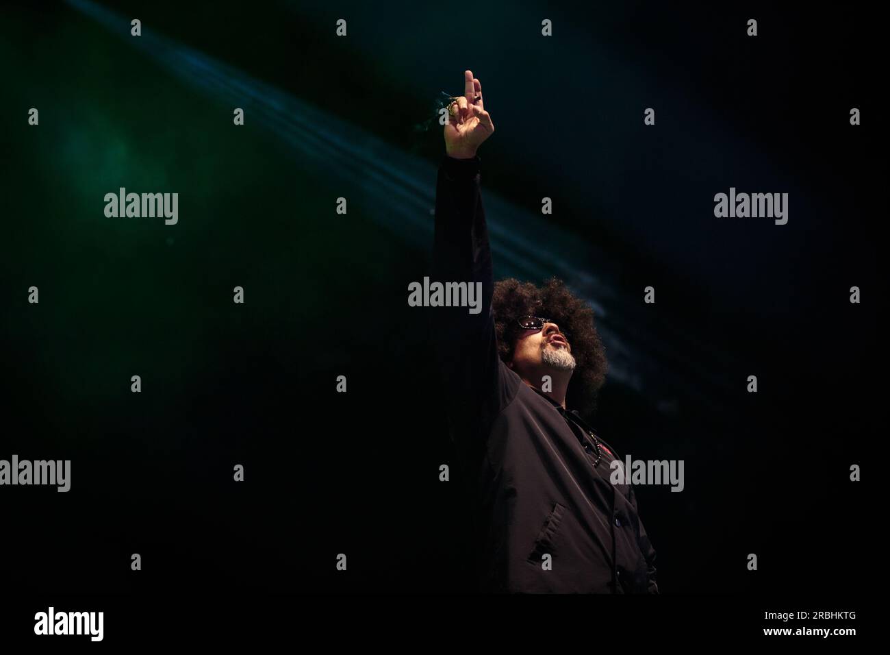 B-Real of Cypress Hill performs on stage sporting sunglasses, a large ...