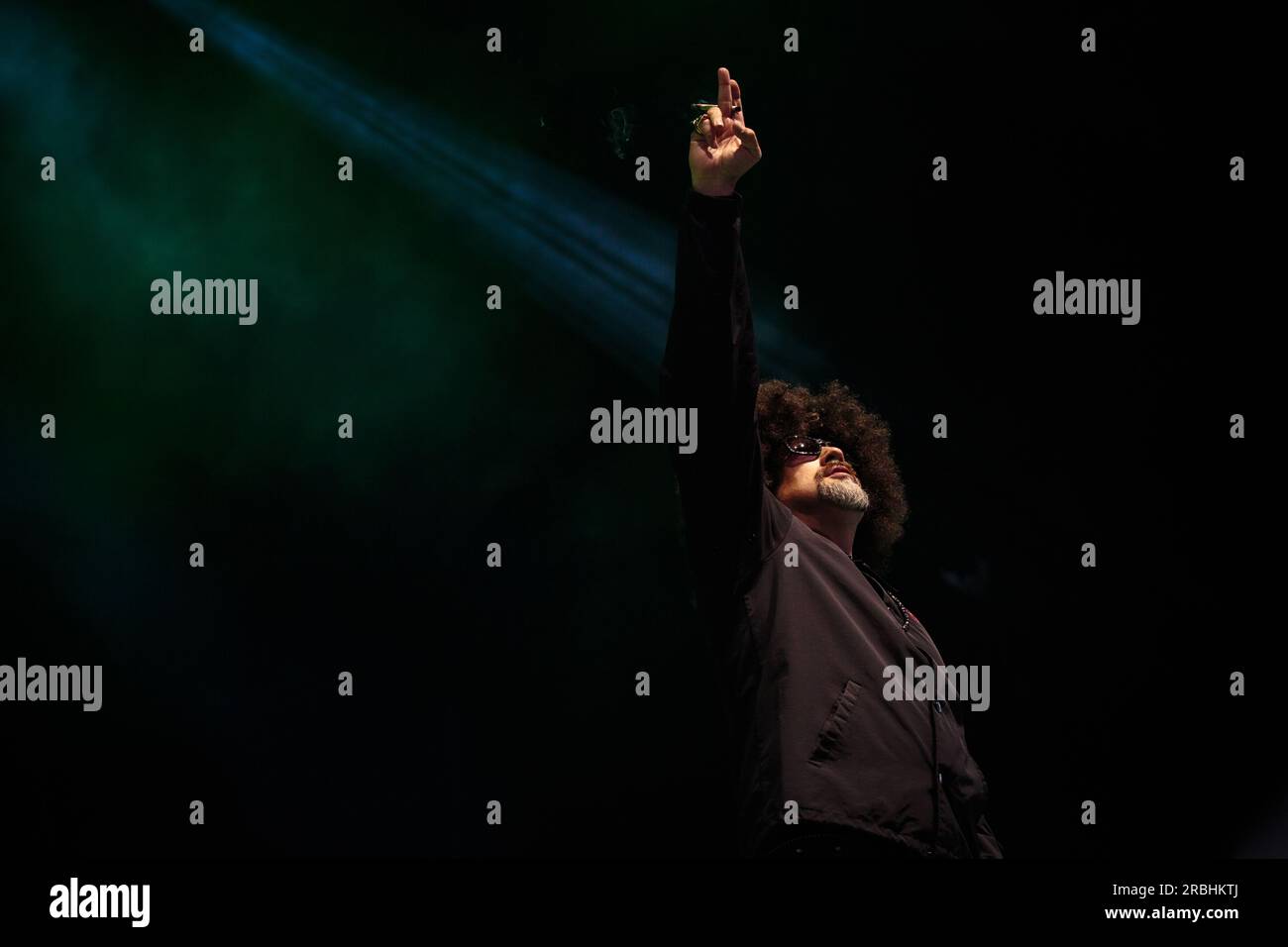 B-Real of Cypress Hill performs on stage sporting sunglasses, a large ...