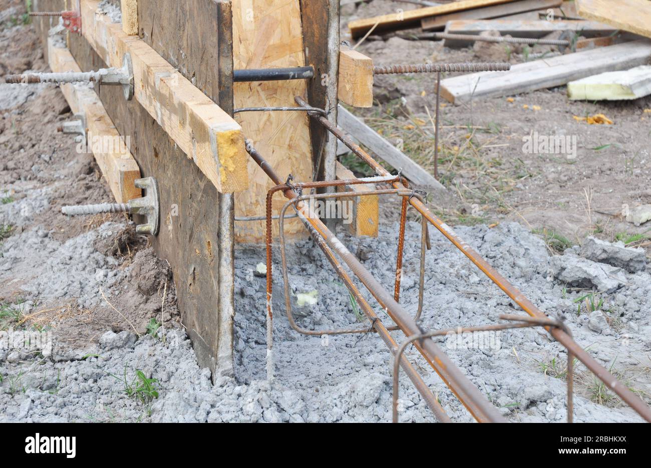 Close up on concrete footer in slabs. Pour concrete footings in wooden ...