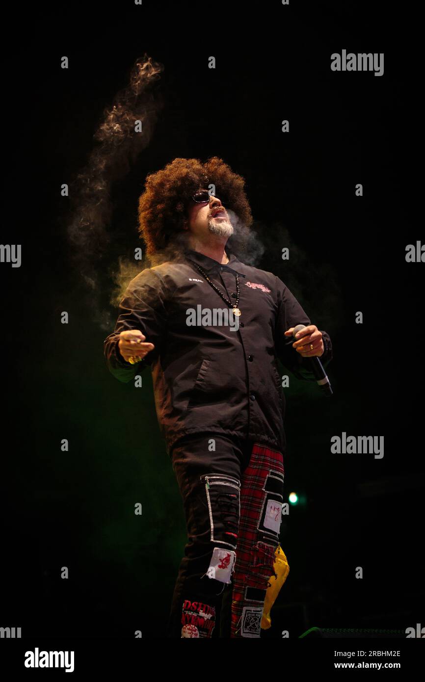 B-Real of Cypress Hill performs on stage sporting sunglasses, a large ...