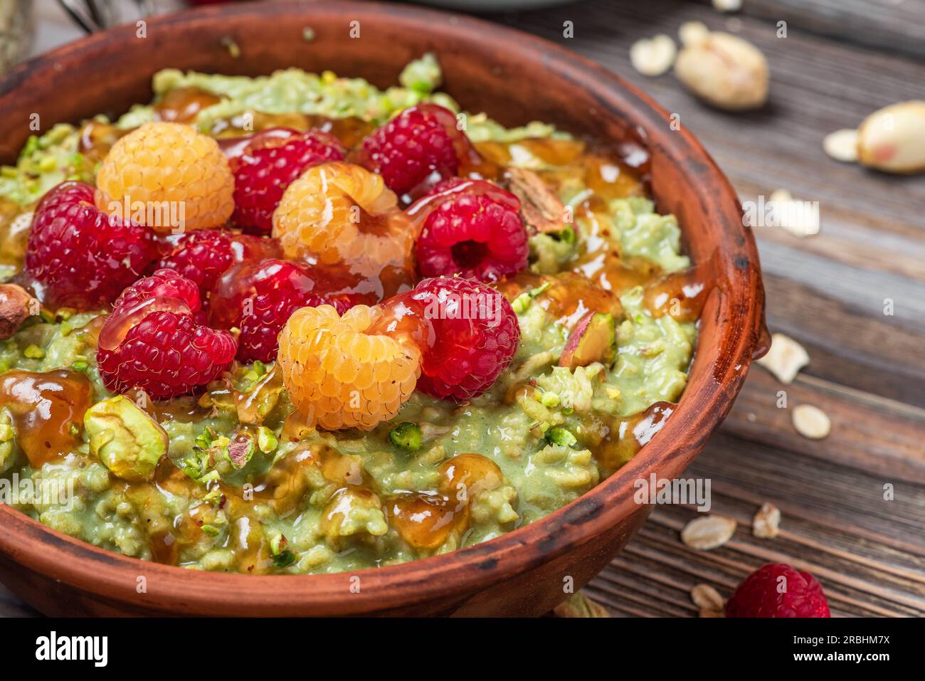 Healthy breakfast. Oatmeal matcha porridge with fresh raspberries ...