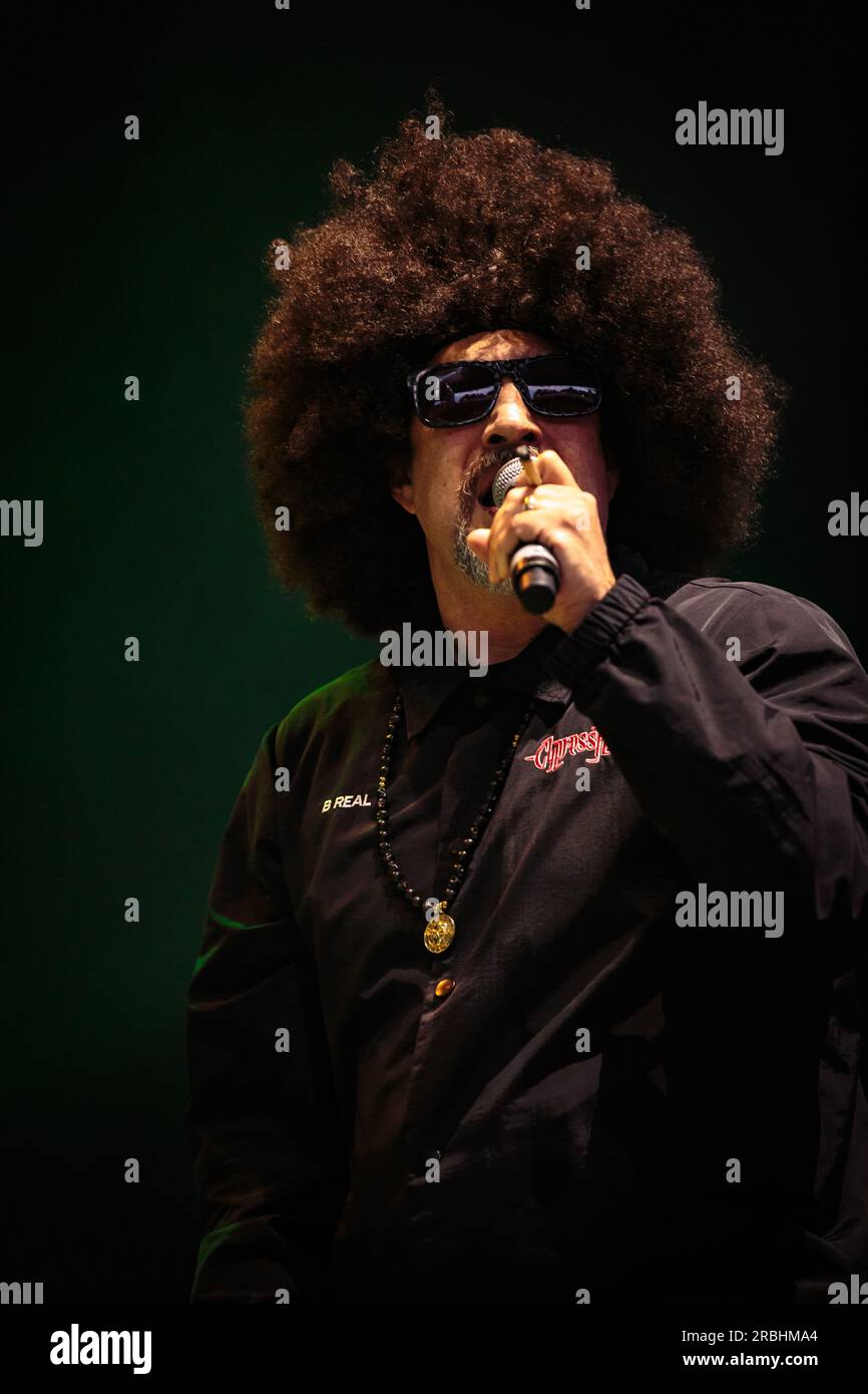 B-Real of Cypress Hill performs on stage sporting sunglasses, a large ...