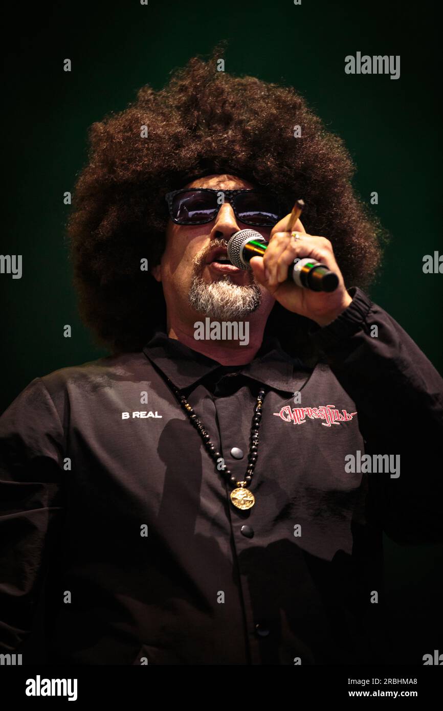 B-Real of Cypress Hill performs on stage sporting sunglasses, a large ...