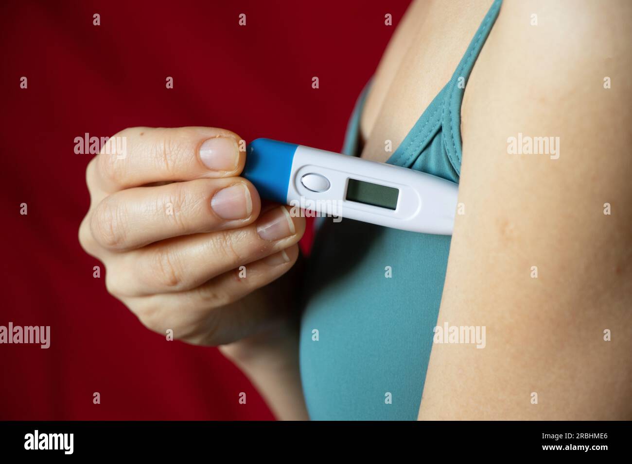 young girl with a thermometer in her hand, high temperature, fever and ...