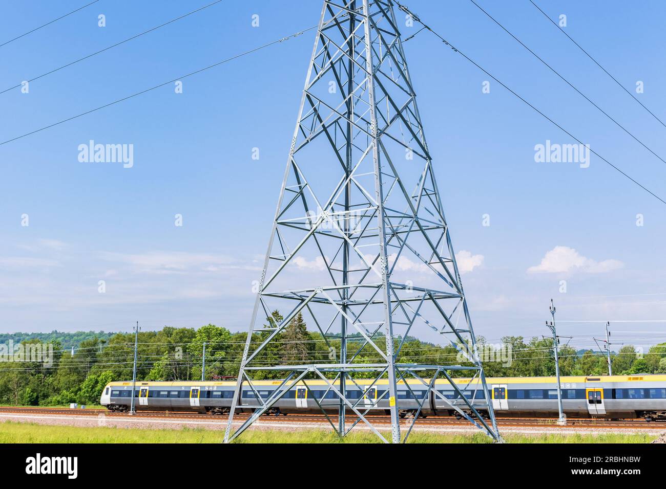 Commuter train by a power line Stock Photo - Alamy