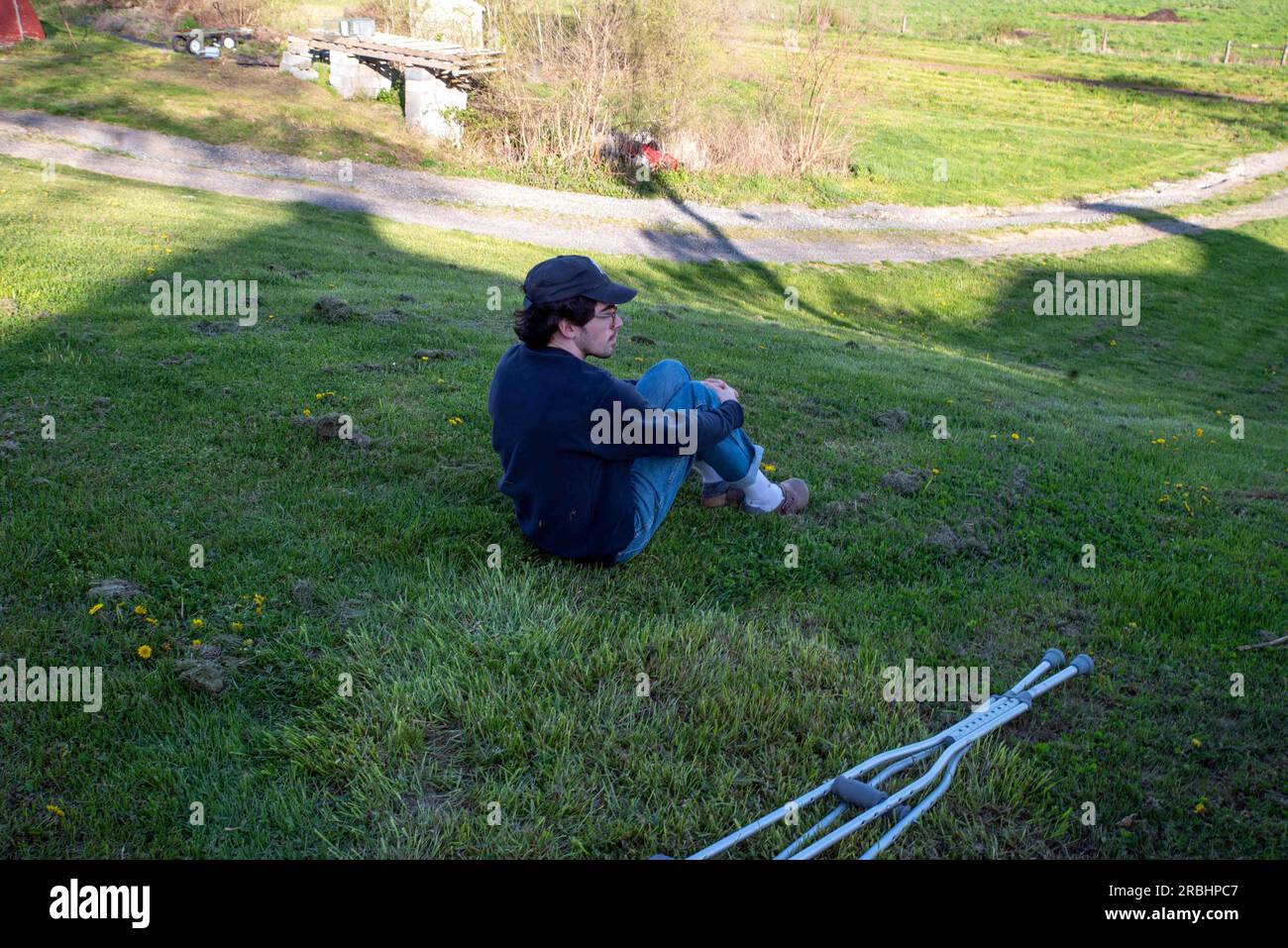 Solitary man sitting on ground hi-res stock photography and images - Alamy