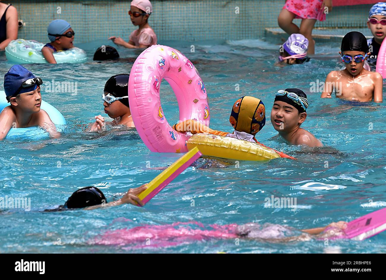 **CHINESE MAINLAND, HONG KONG, MACAU AND TAIWAN OUT** Children enjoy coolness in a swimming pool ...