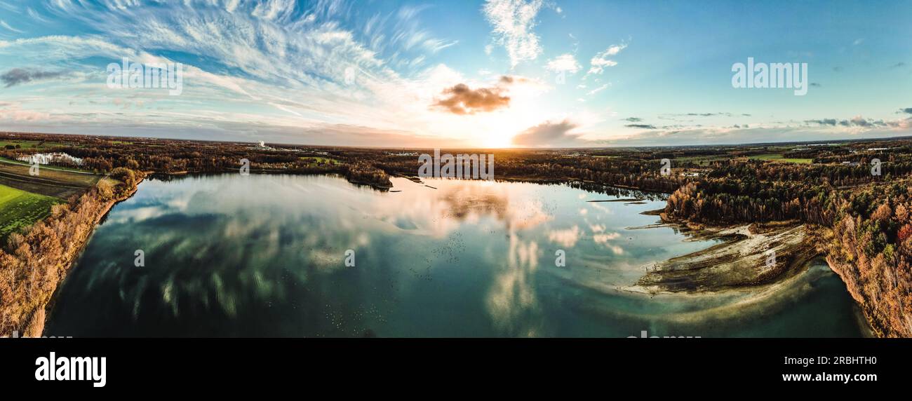 An immersive panoramic aerial view of a dramatic and vibrant sunset ...