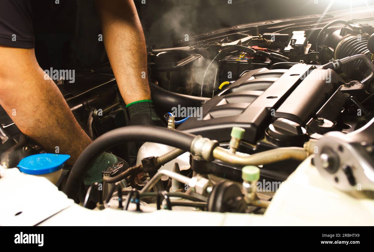 Auto mechanic working in auto repair service. Car mechanic working on a ...