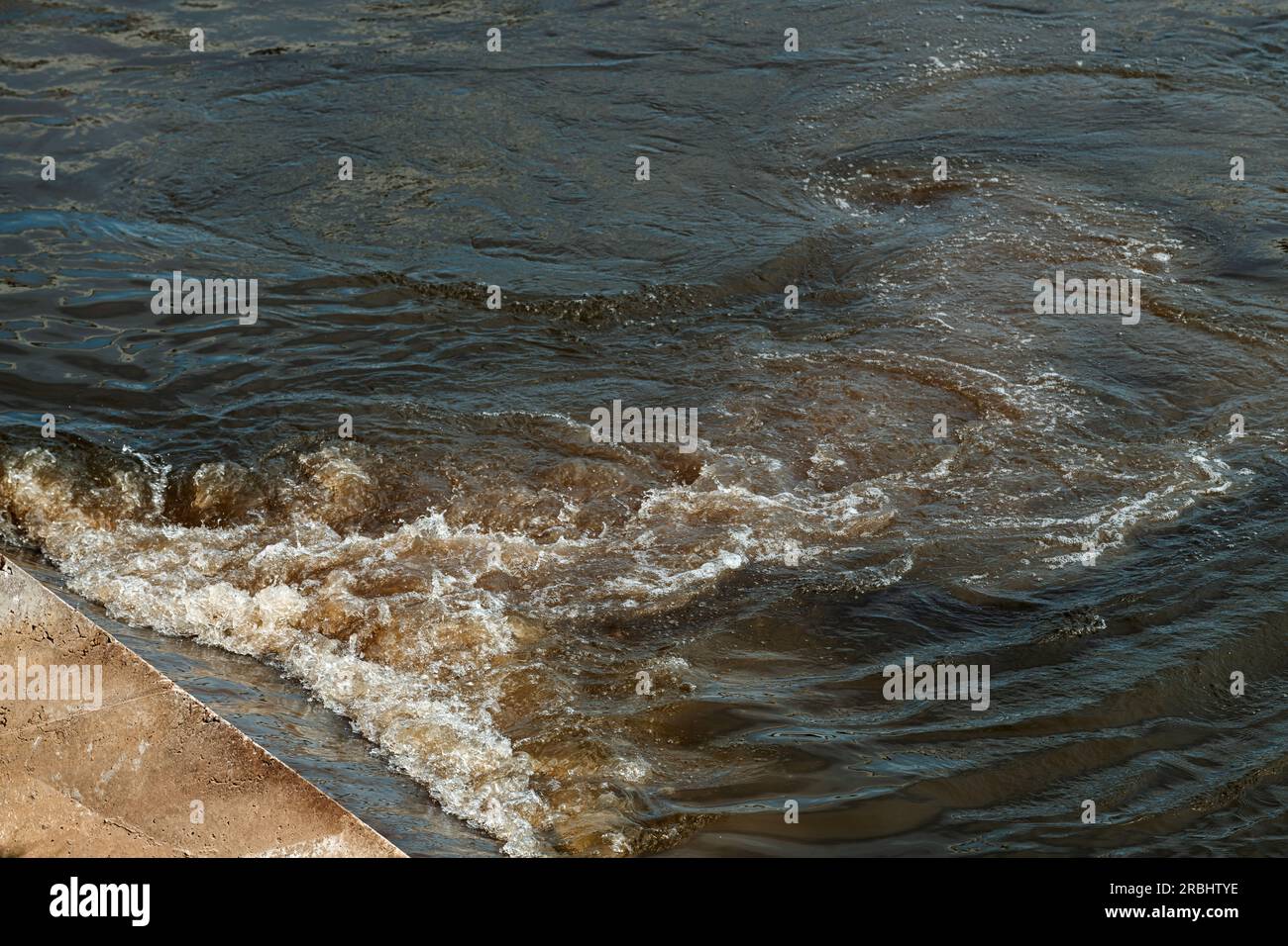 Sewage pipe outfall into the river, water pollution and environmental ...