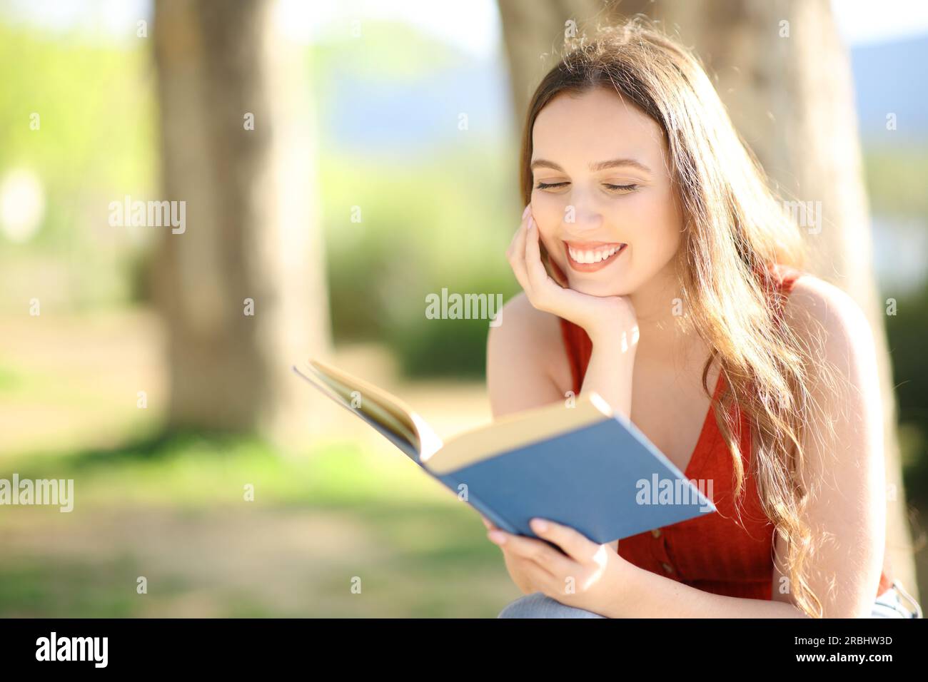 Happy teenager girl reading hi-res stock photography and images - Alamy