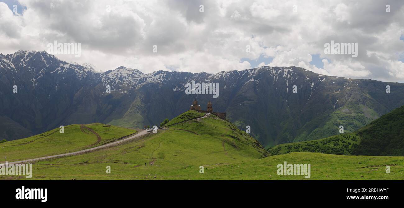 Panoramic landscaped of mountain range, with Gergeti trinity church ...