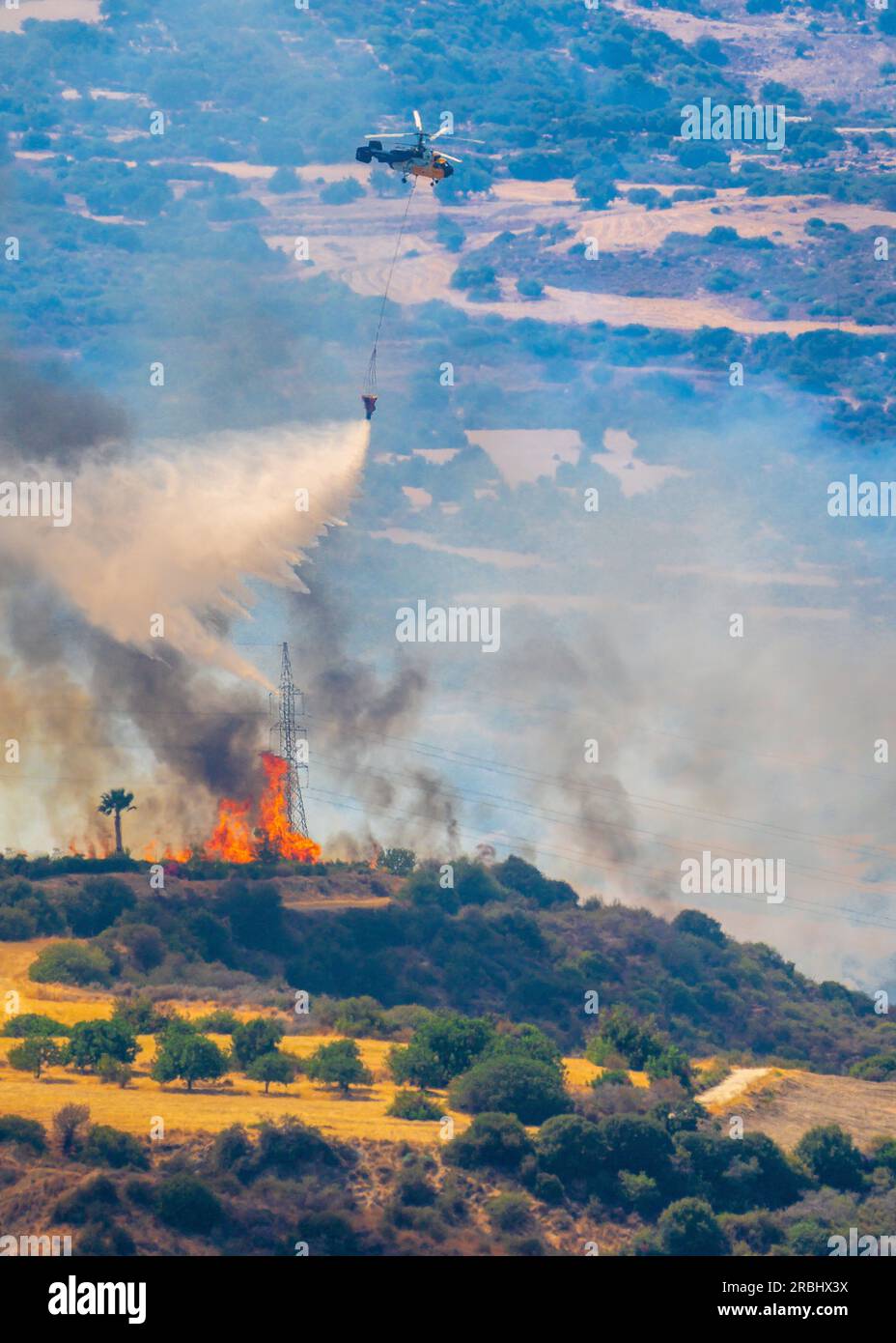 helicopter dropping water on a wild bush fire Stock Photo - Alamy