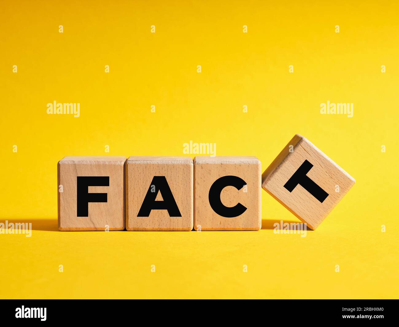 The word Fact on wooden cubes with yellow background. True information ...