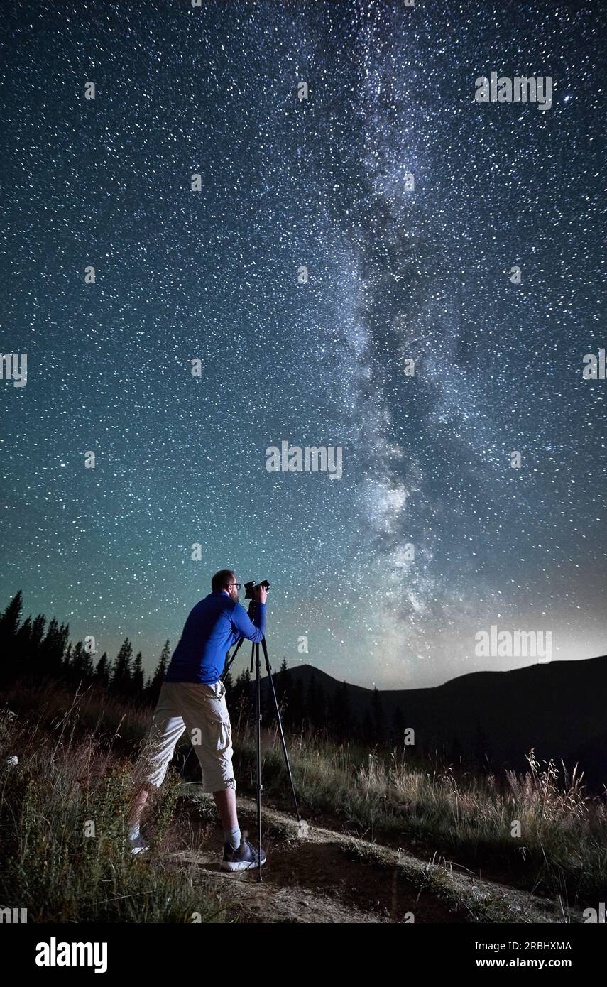 Professional photographer taking photos of Milky Way. Young male ...