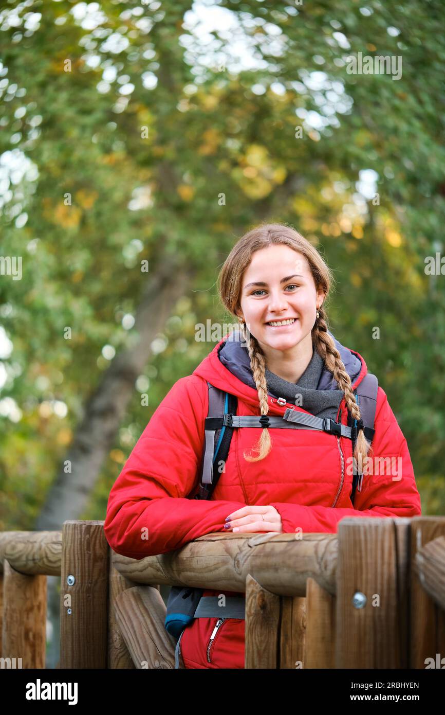 Happy trekker posing looking at you in the forest Stock Photo - Alamy