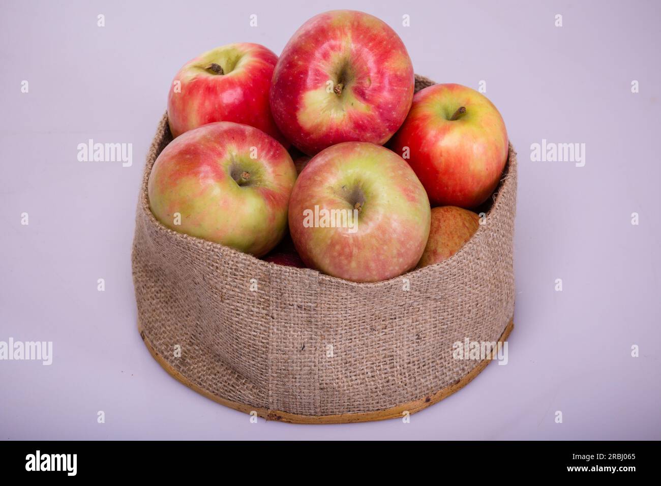 Red Apple in the basket On the white piece Stock Photo - Alamy
