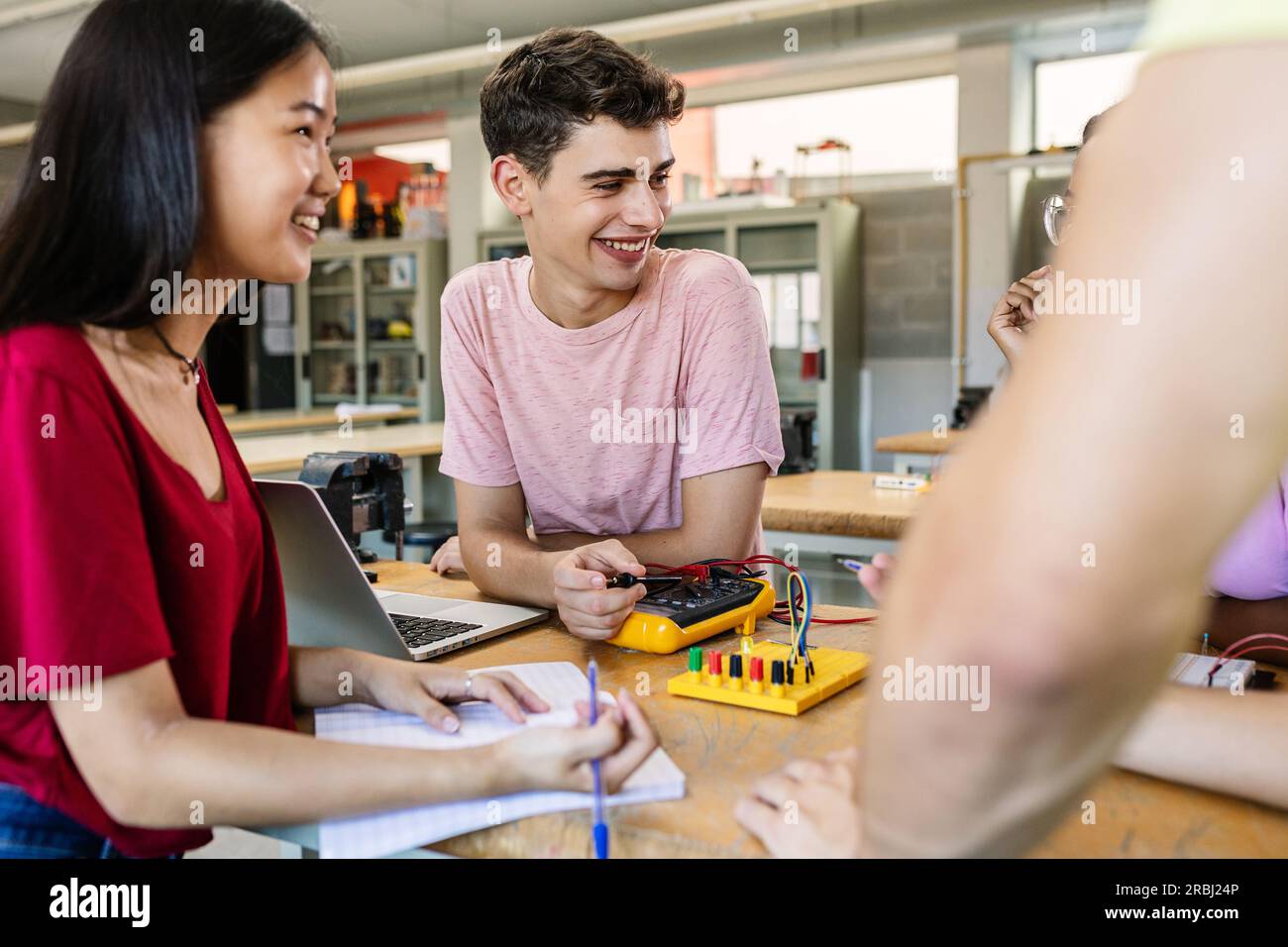 Group of diverse young tech students learning together at technology ...