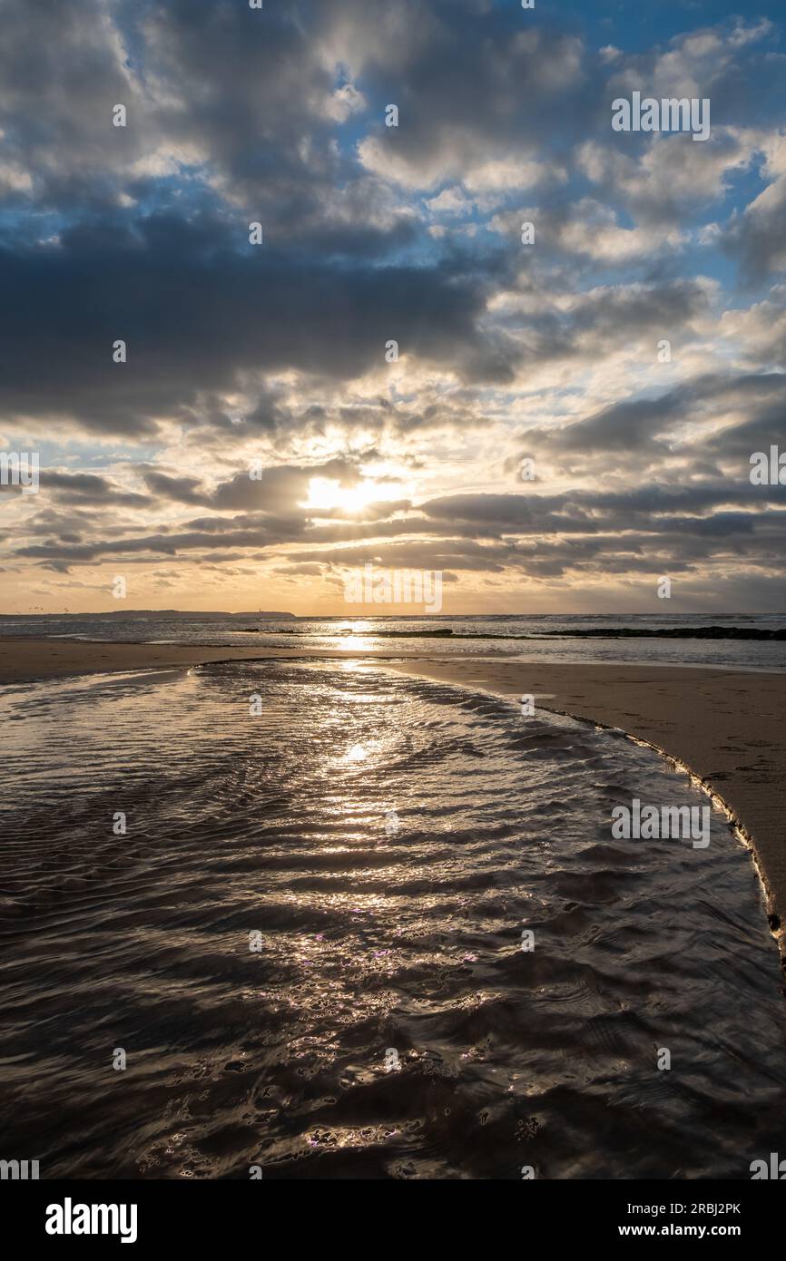 A magnificent capture of a dramatic sunset sky mirrored in the sandy ...