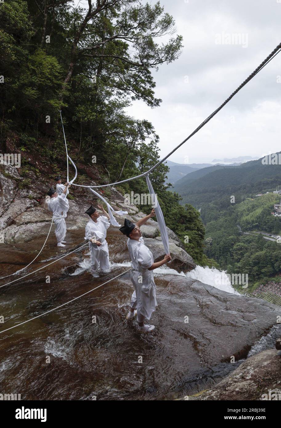 Shinto priests take part in an event to exchange a "shimenawa" sacred ...
