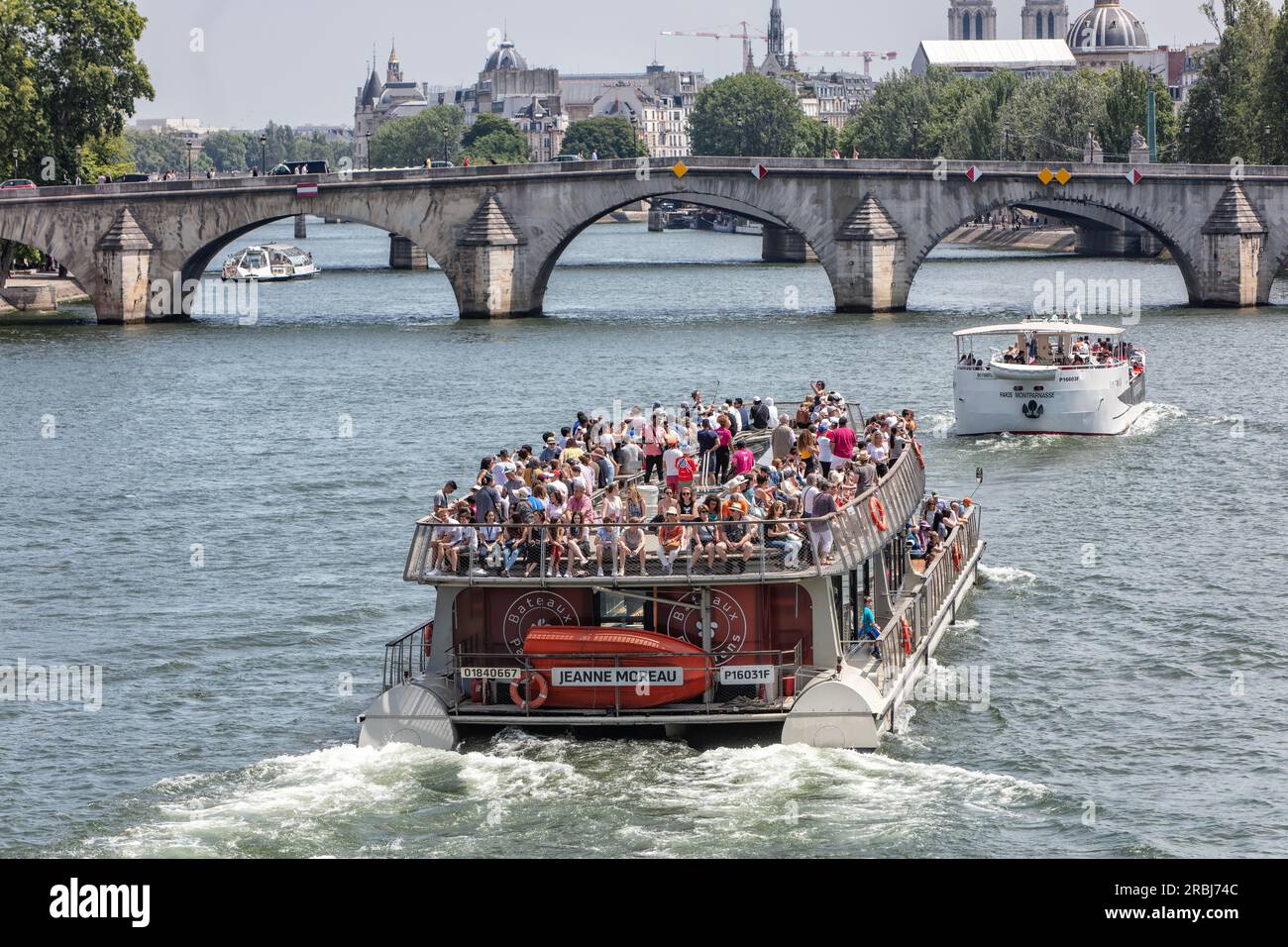 Romantic Paris. People on Bateaux Mouches river cruise boats on River ...
