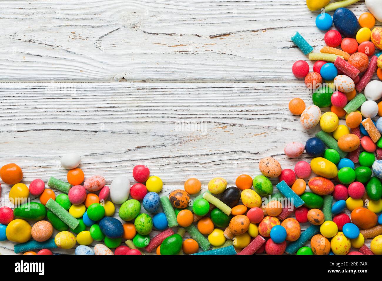 Mixed collection of colorful candy, on colored background. Flat lay ...