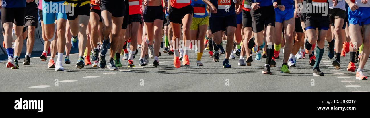 legs group of runners men and women run marathon race, panoramic view ...