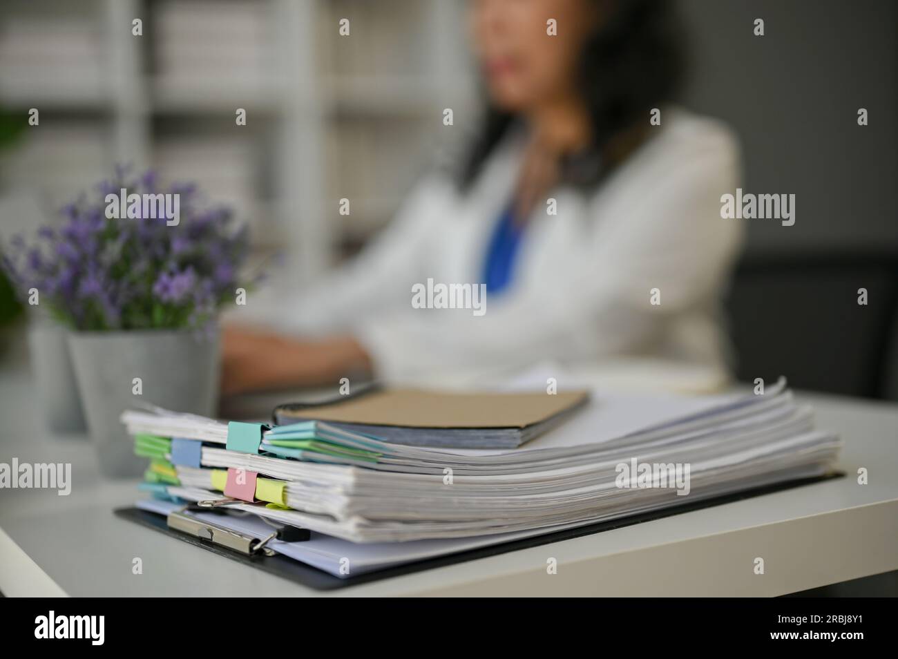 A close-up image of business documents and reports is on an office desk ...