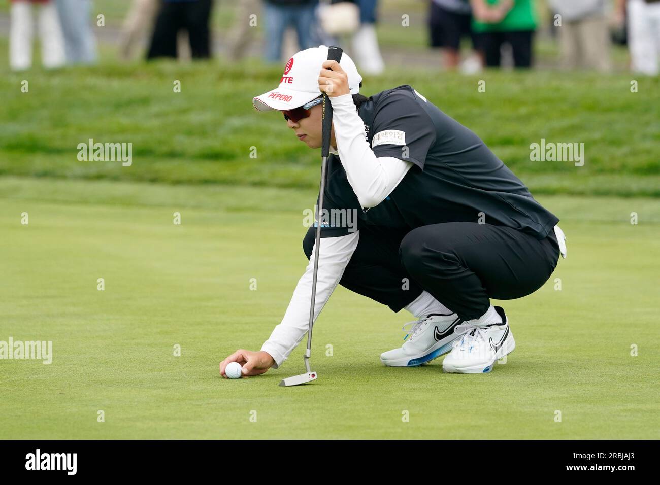 Hyo Joo Kim measures her putt on the sixth green during the first round ...