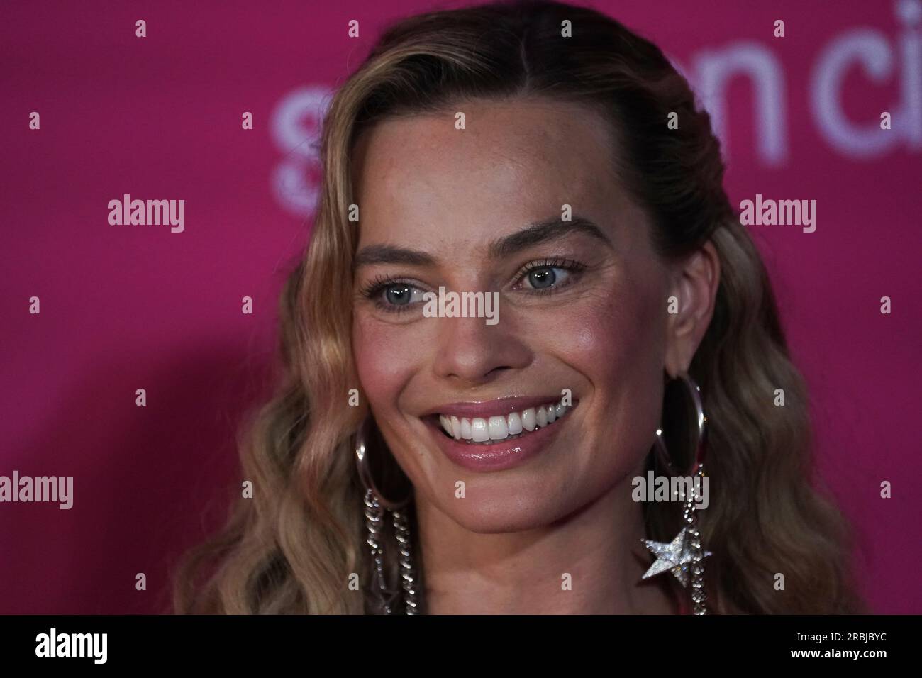 Actress Margot Robbie poses for a photo on the red carpet of the Barbie ...