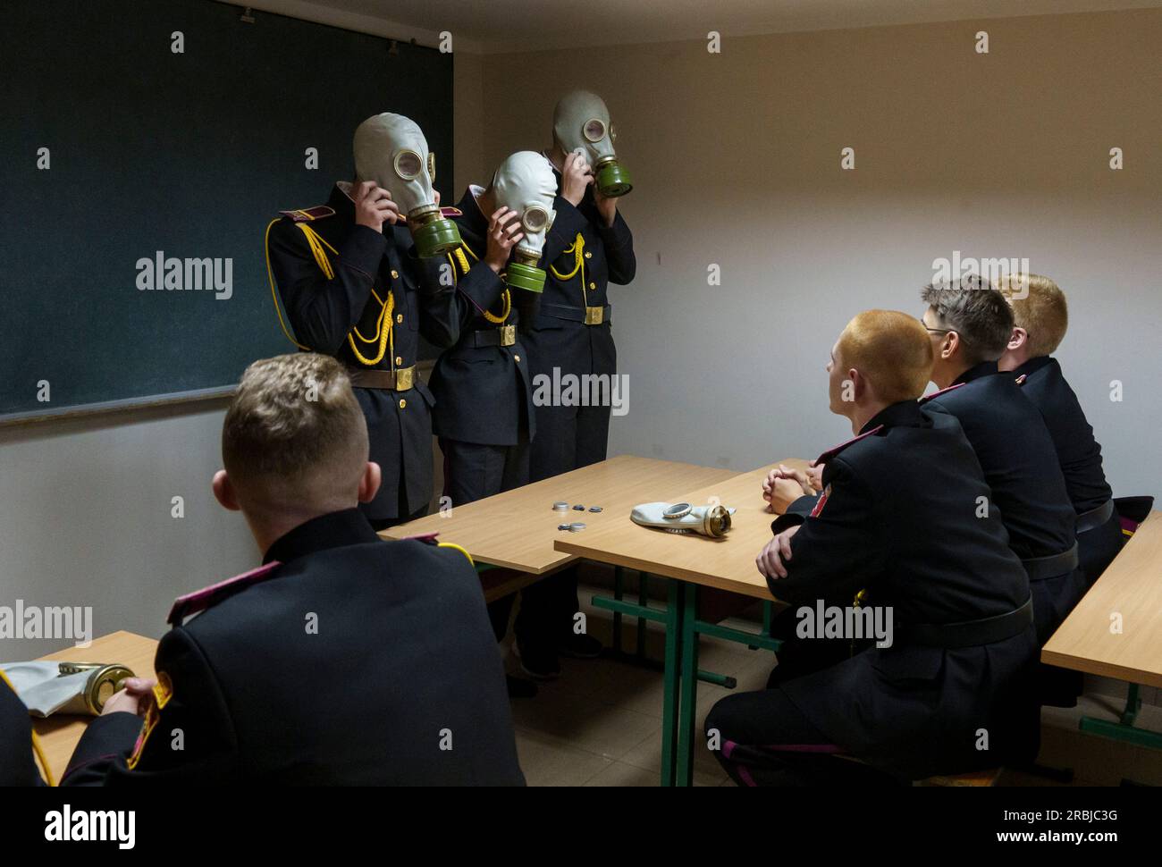 Cadets practice with gas masks during a lesson in a bomb shelter on the ...