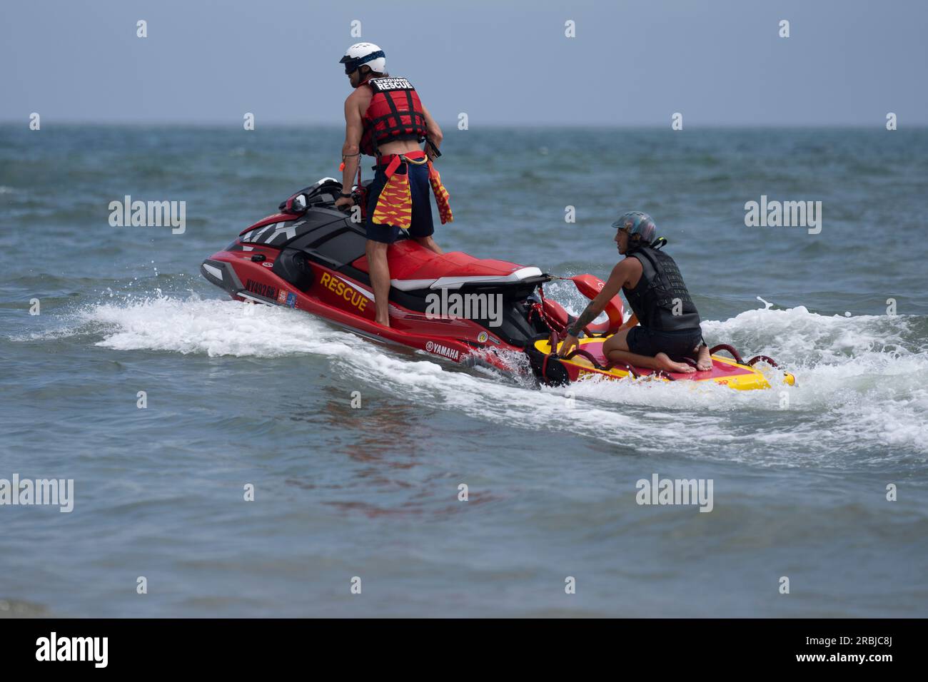 Lifeguards ride a jet ski during a shark patrol run at Jones Beach ...