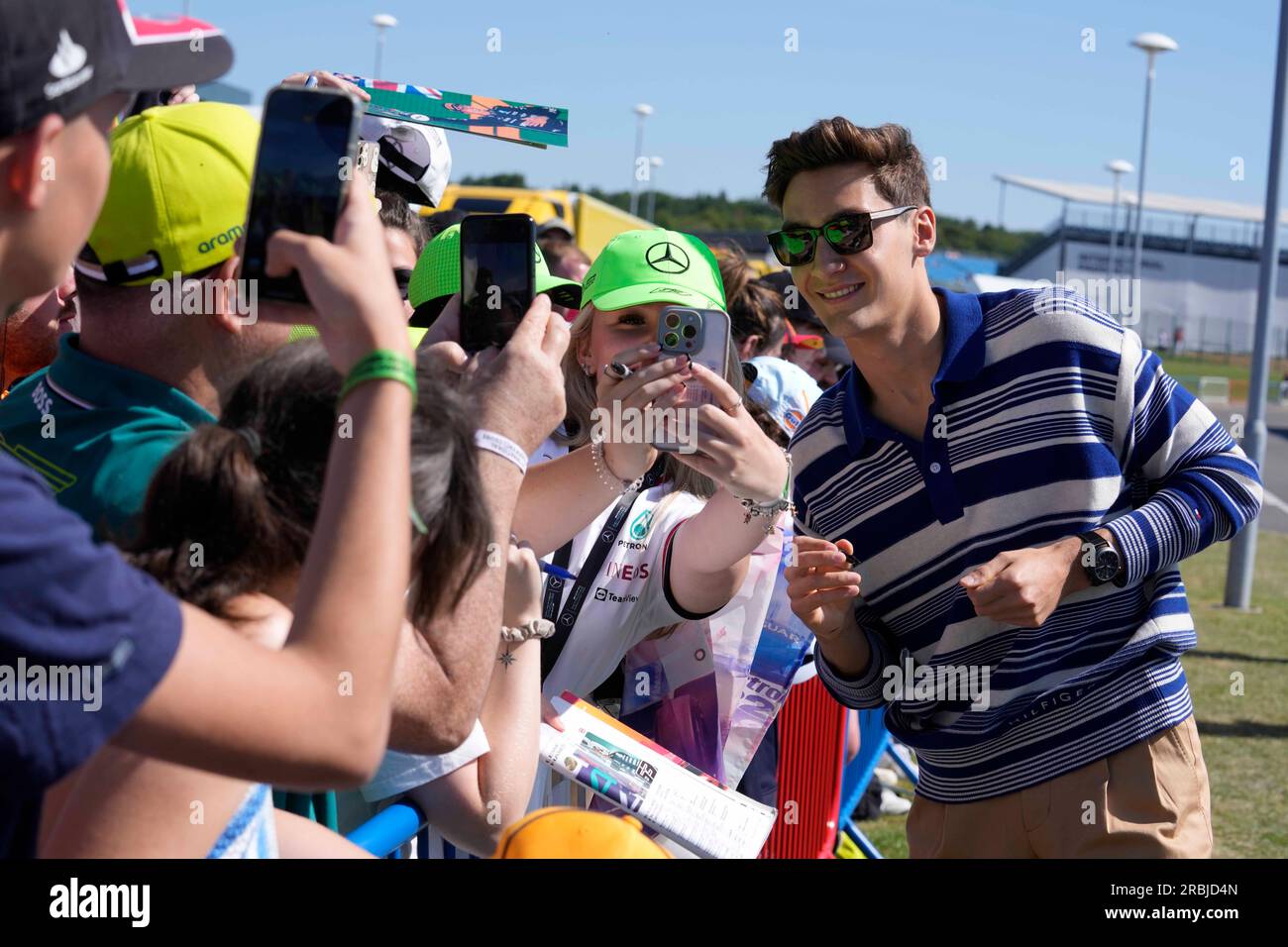 Mercedes driver George Russell of Britain meets fans as he arrives at ...