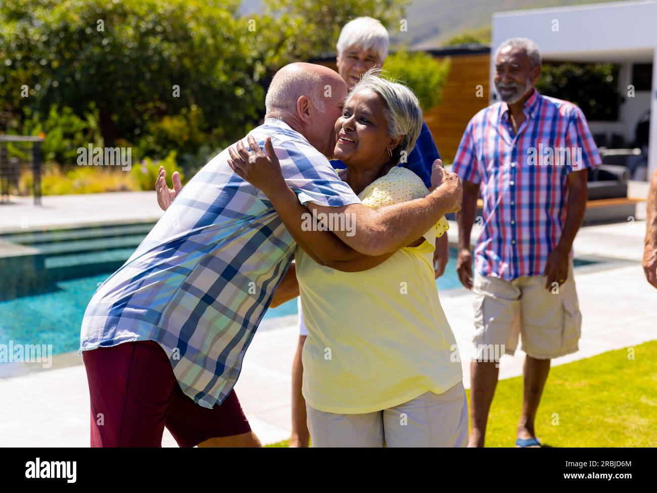 Happy senior diverse people having party and embracing in garden ...