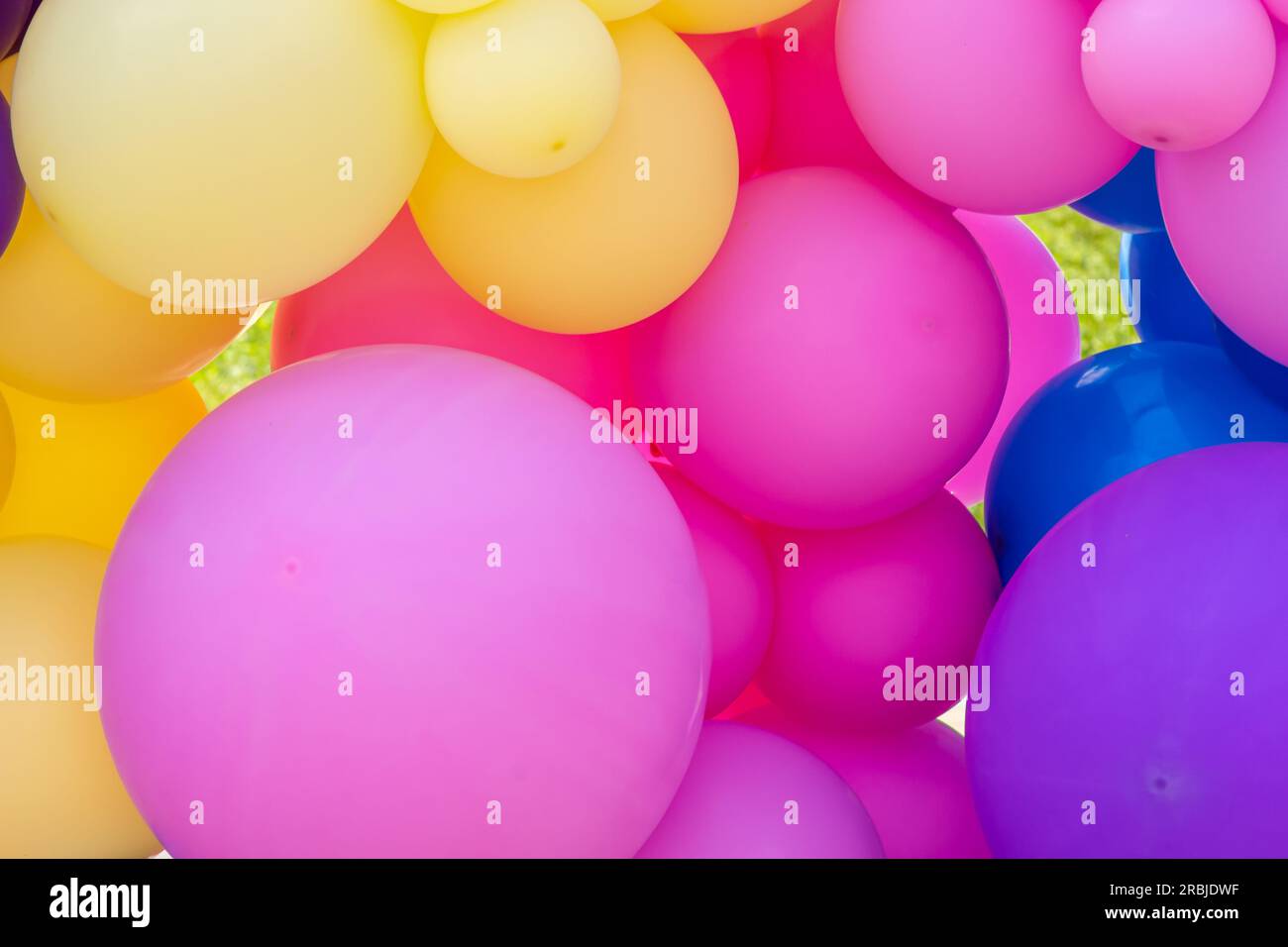 Bright abstract background of jumble of rainbow colored balloons ...