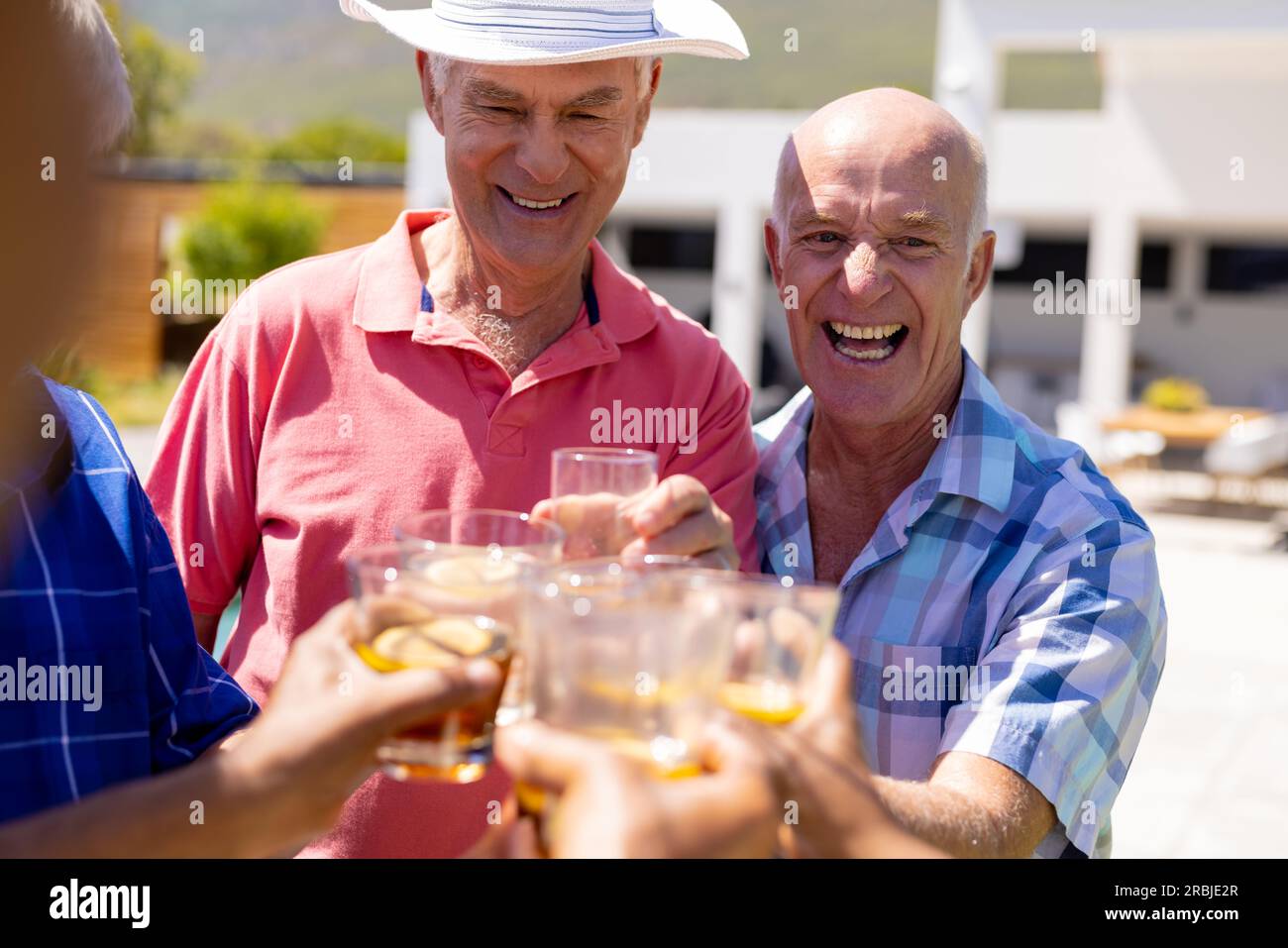 Happy senior diverse people making toast and smiling in garden. Senior ...
