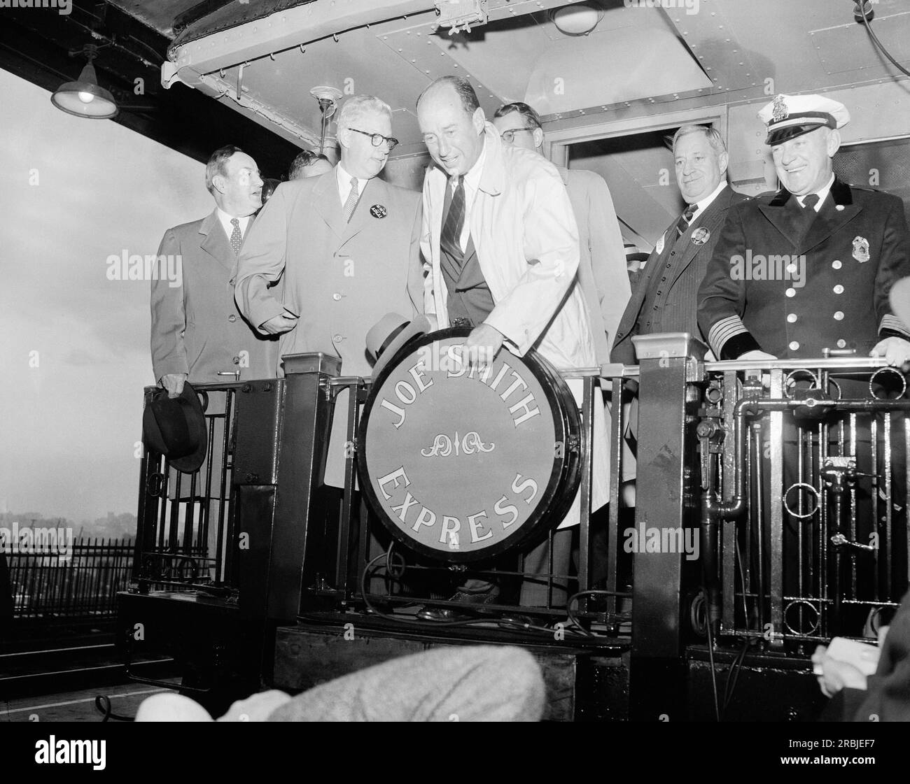 Adlai Stevenson points to the "Joe Smith Special" sign on the back of ...