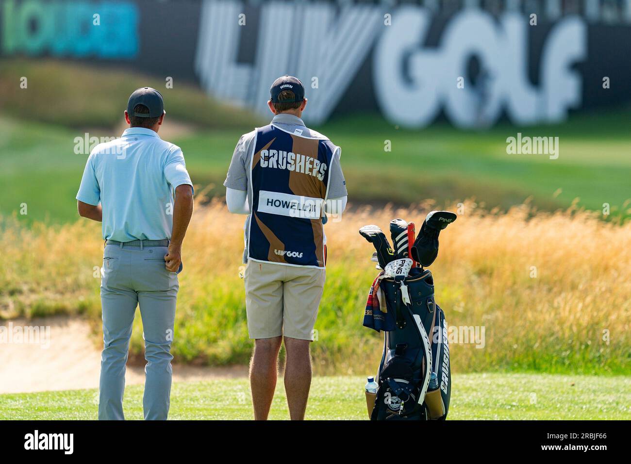 Charles Howell III of Crushers GC and his caddie wait on the 18th ...