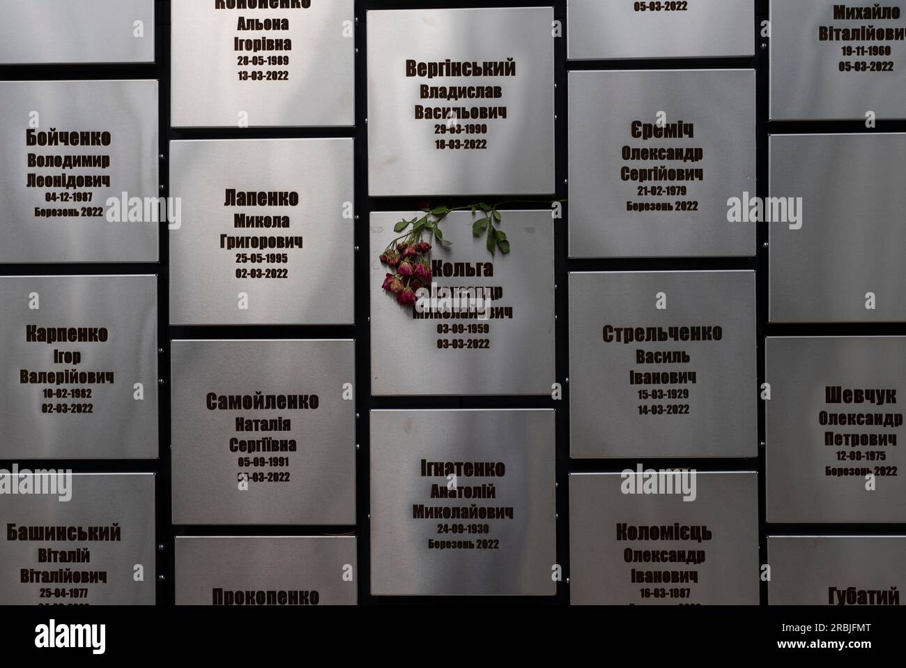 Flowers are placed on a memorial wall to honor residents who were ...