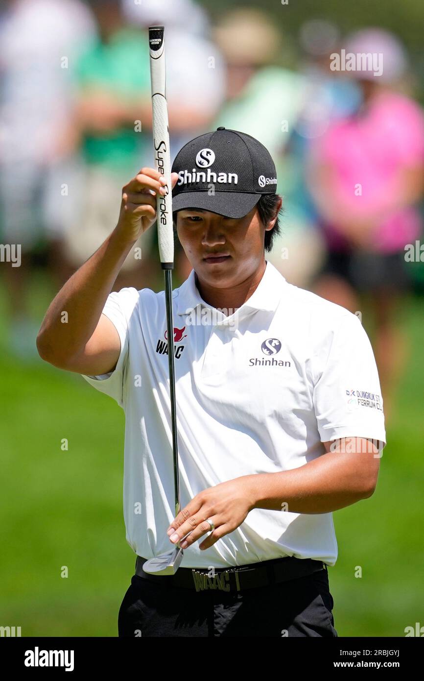 S.H. Kim, of South Korea, lines up his putt on the ninth green during ...