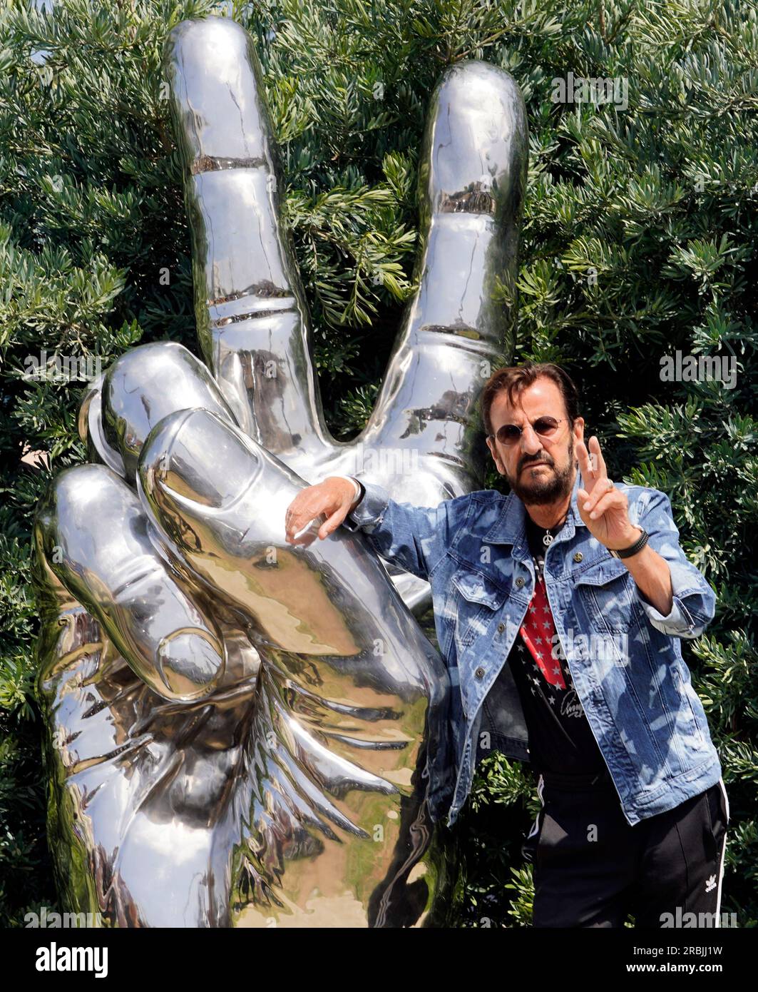 Ringo Starr poses at the "Peace and Love" statue during his annual ...