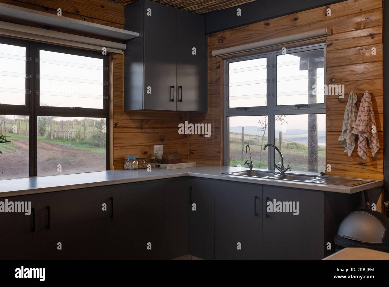 Interior of empty kitchen in log cabin over green countryside Stock ...