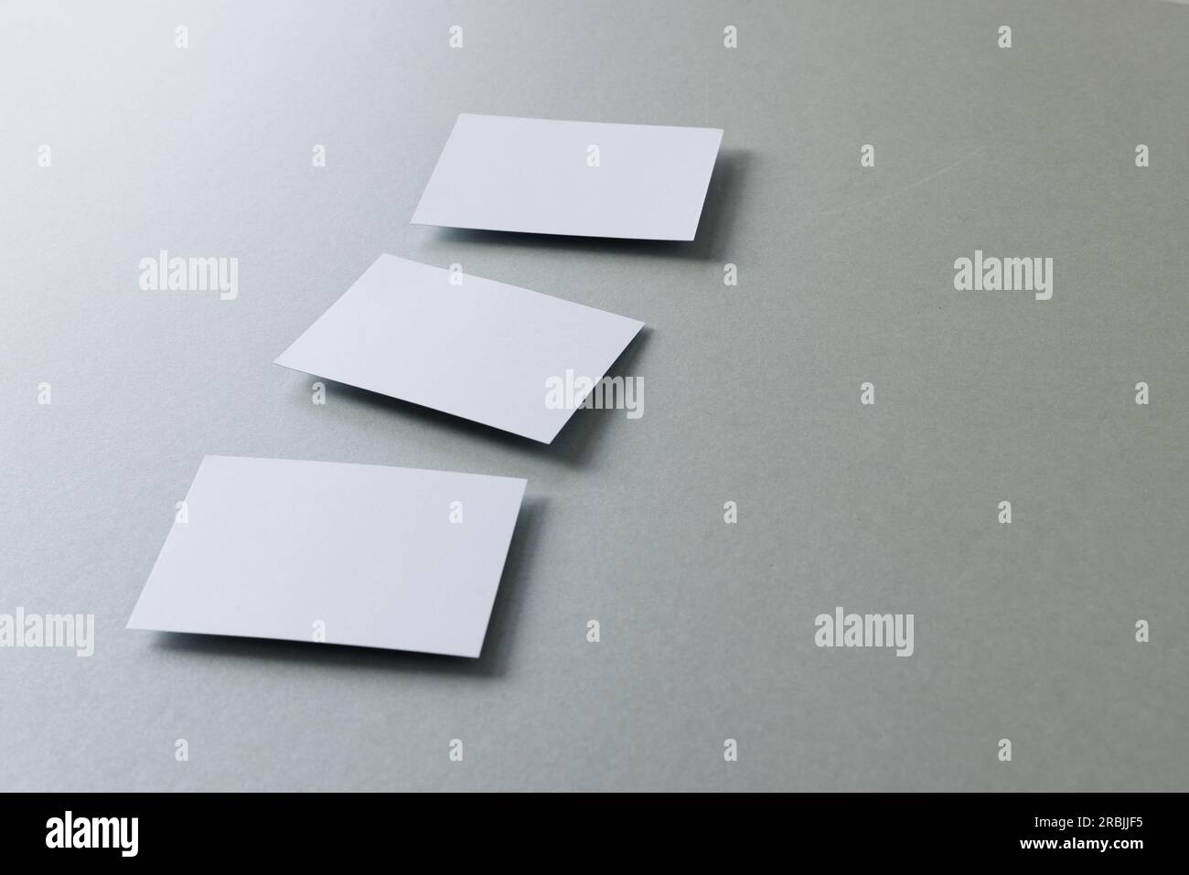White business cards with copy space on grey background Stock Photo - Alamy