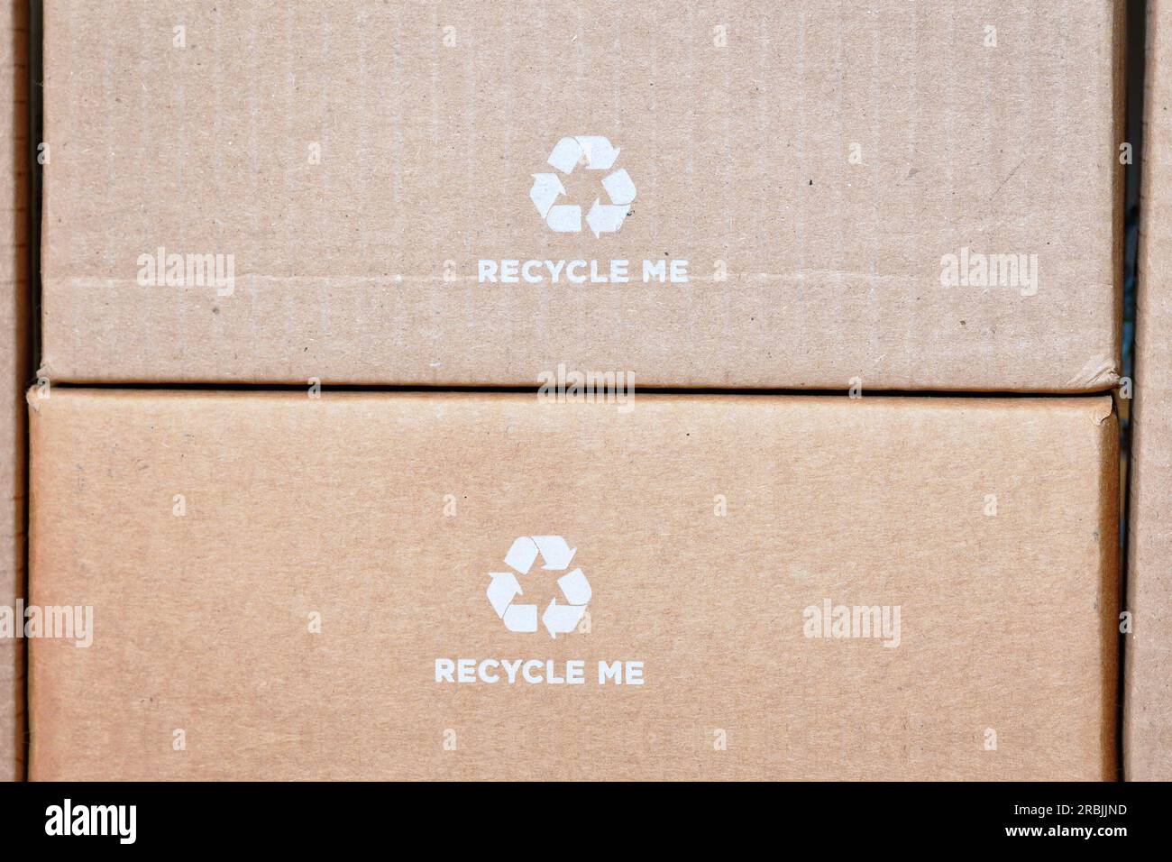Cardboard boxes with recycling arrow symbol and text saying Recycle me ...
