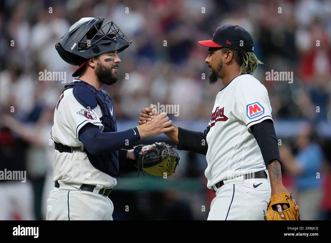 Cleveland Guardians catcher Cam Gallagher, left, and relief pitcher ...