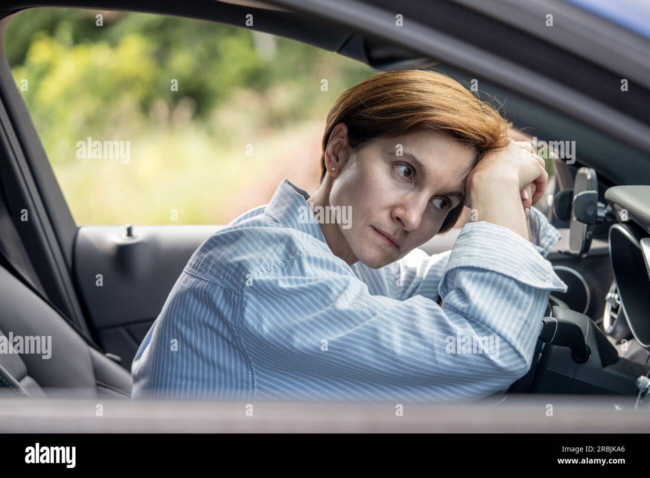 Tired fatigue woman driving car having problems on road waiting in ...